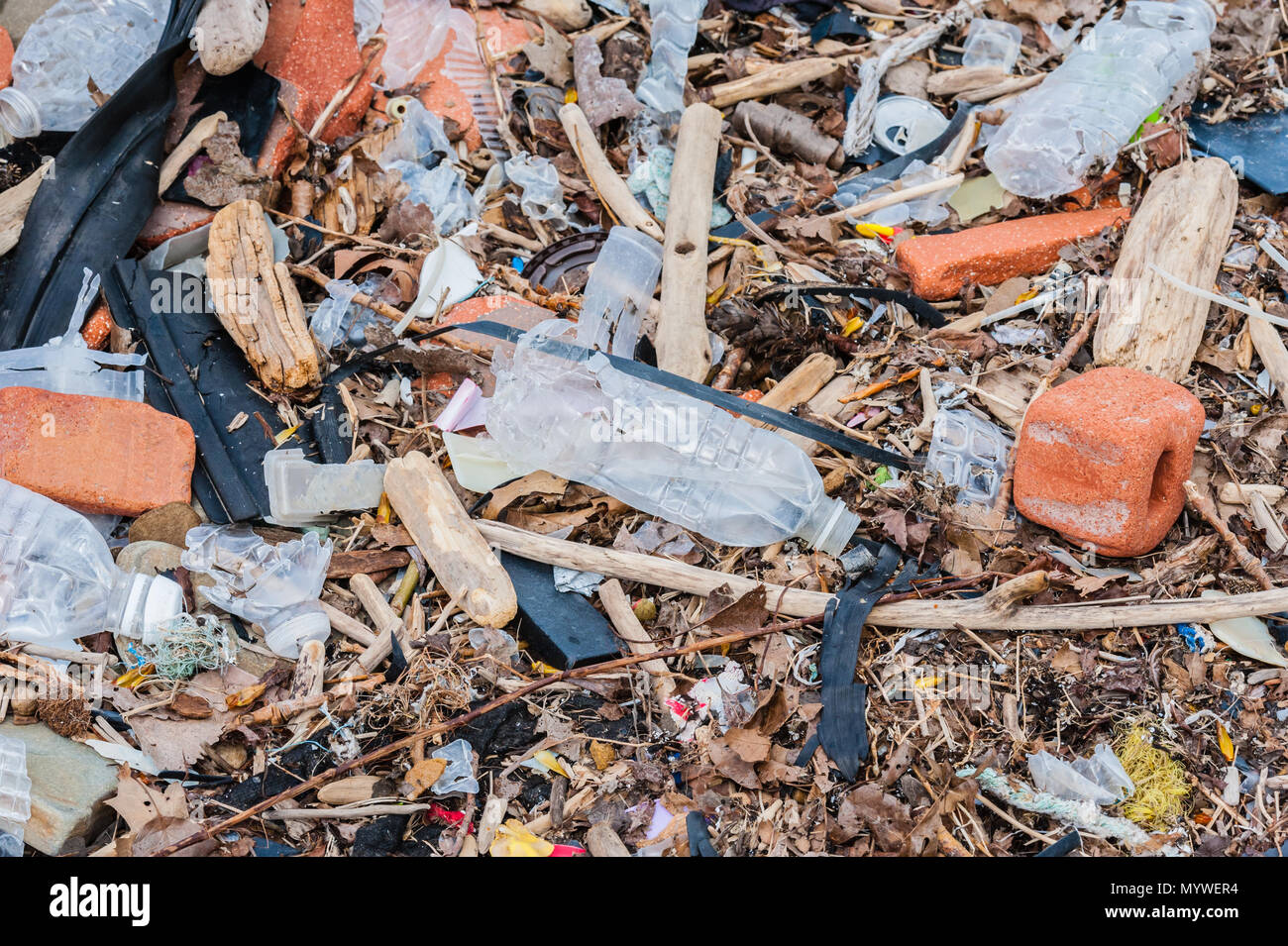 Random plastic, waste, garbage, debris, and bricks scattered on ground ...