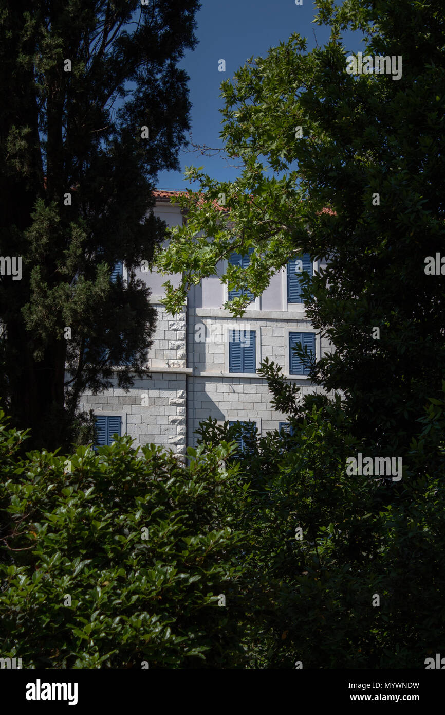 Photo of a building behind trees Stock Photo - Alamy
