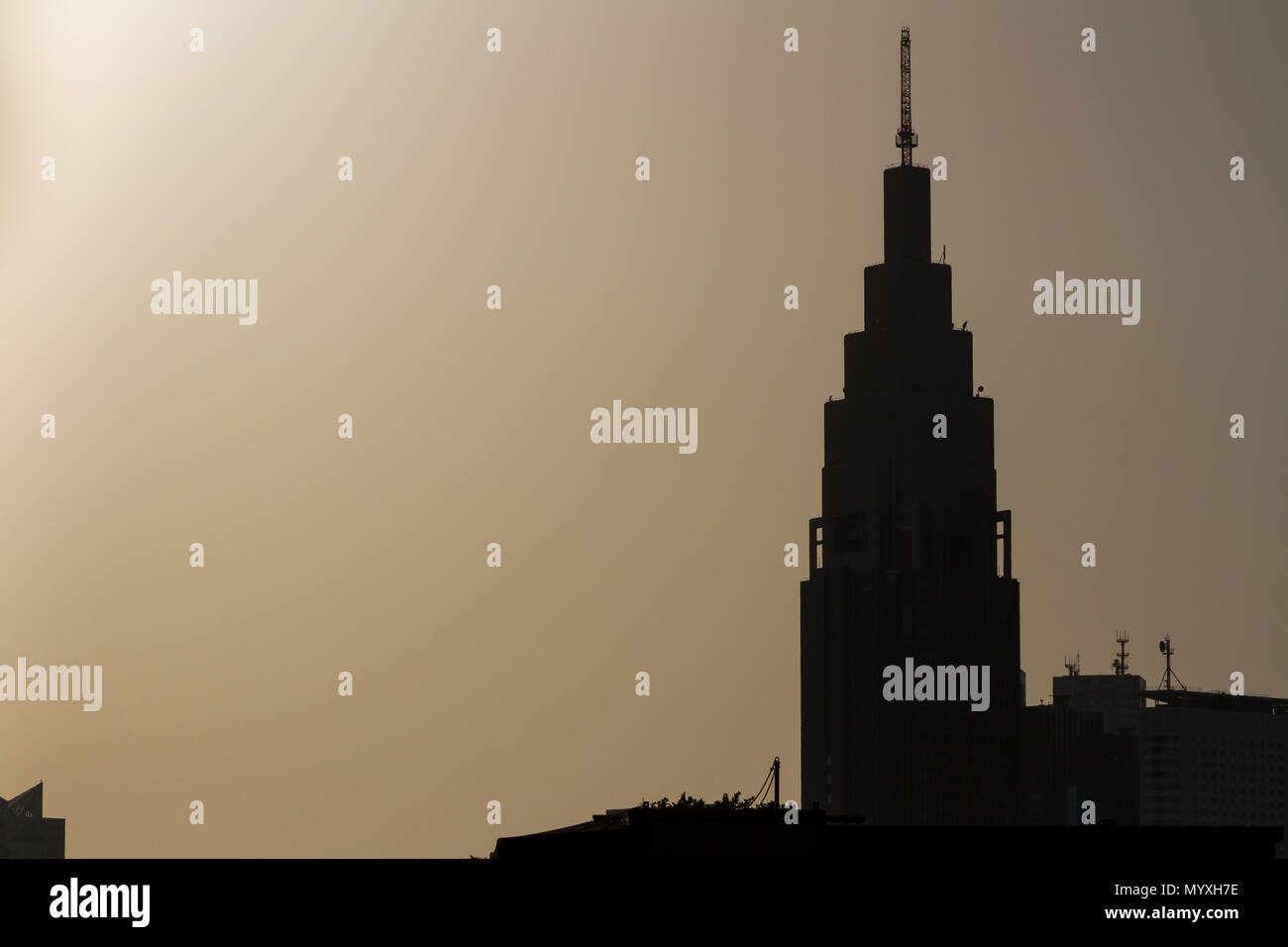 The distinctive NTT Docomo Tower in silhouette. Shinjuku, Tokyo, Japan ...