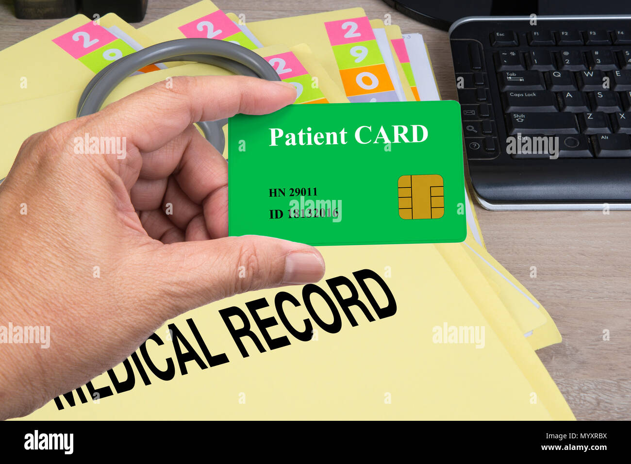 Someone hand holding patient smart card with medical record floder on ...