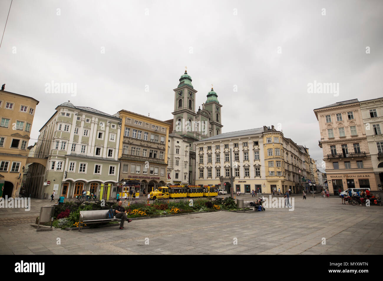A tourist train passes through the main square (Hauptplatz) of the old ...