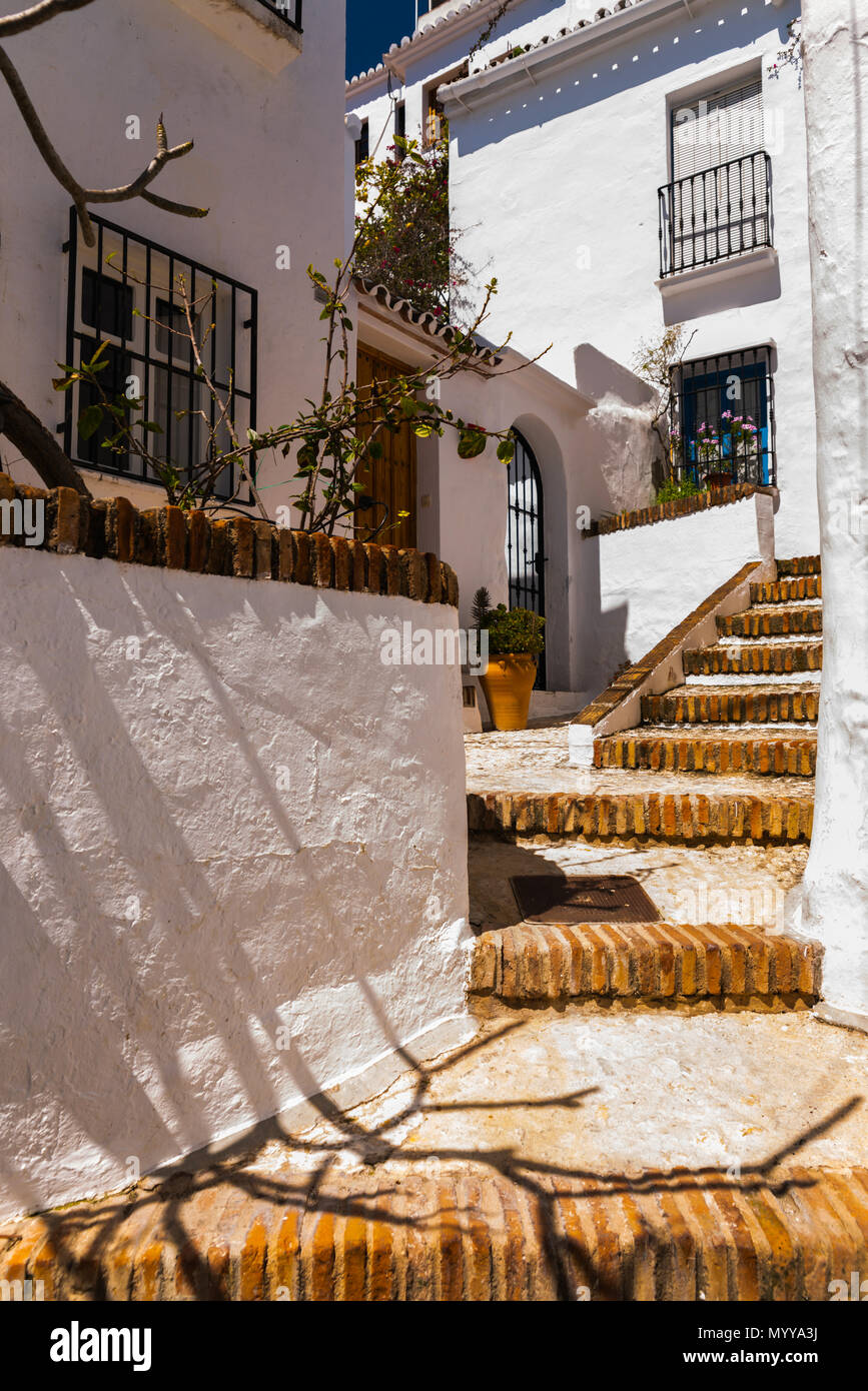 beautiful and picturesque narrow street with white facades of buildings ...