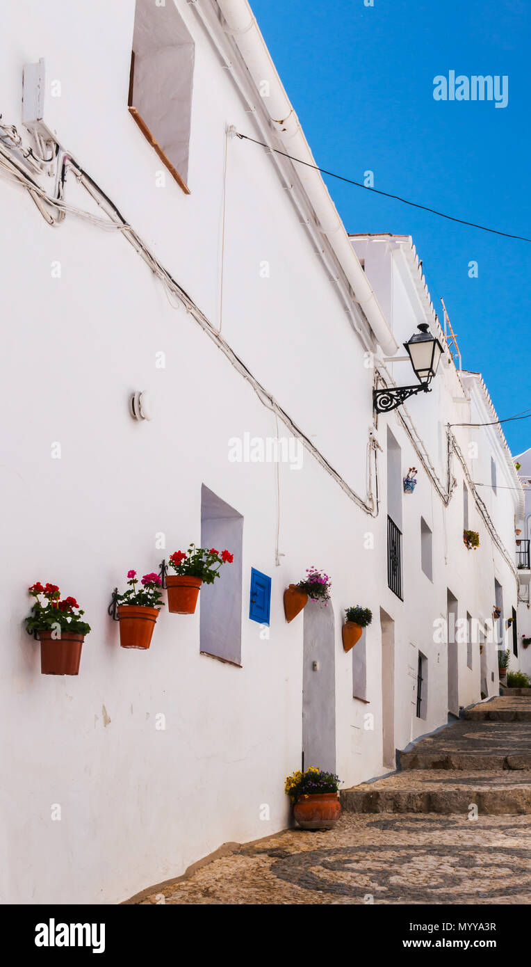 beautiful and picturesque narrow street with white facades of buildings ...