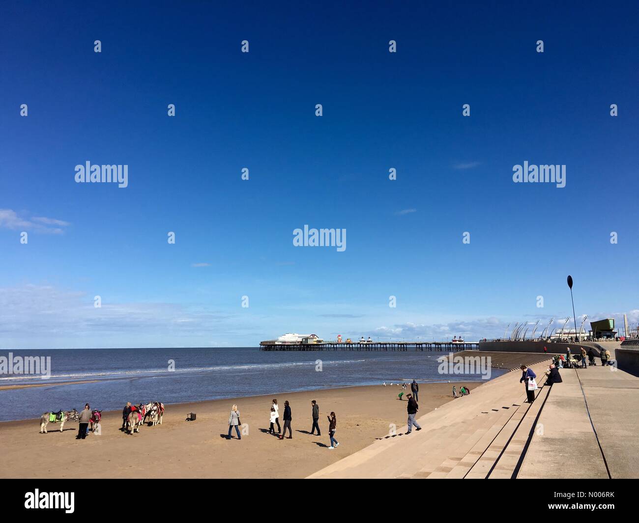 UK Weather sunny day in Blackpool. North pier and donkey rides on beach ...