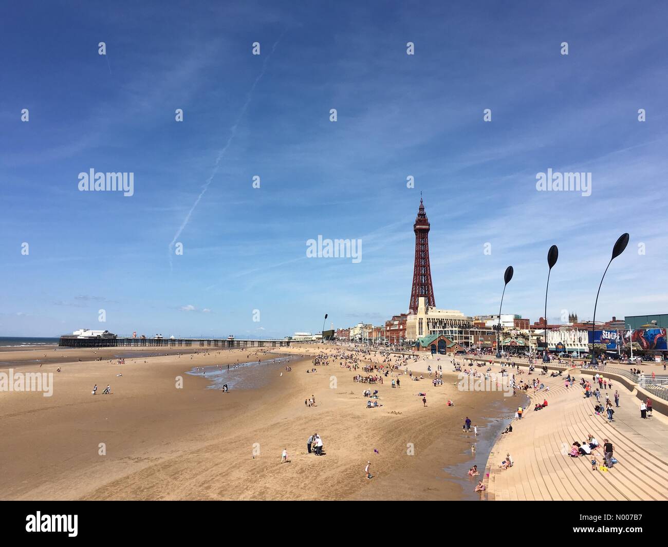 UK weather: Sunny afternoon at Blackpool. Families out on beach during ...