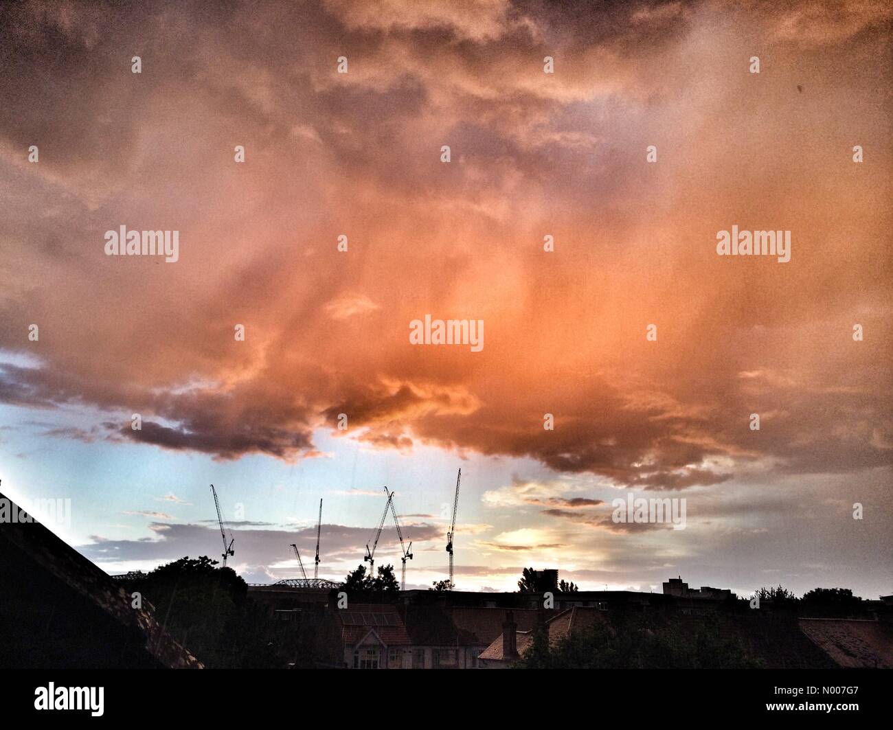 Manor Rd, London, UK. 12th June, 2016. A lurid and fiery sunset appears ...