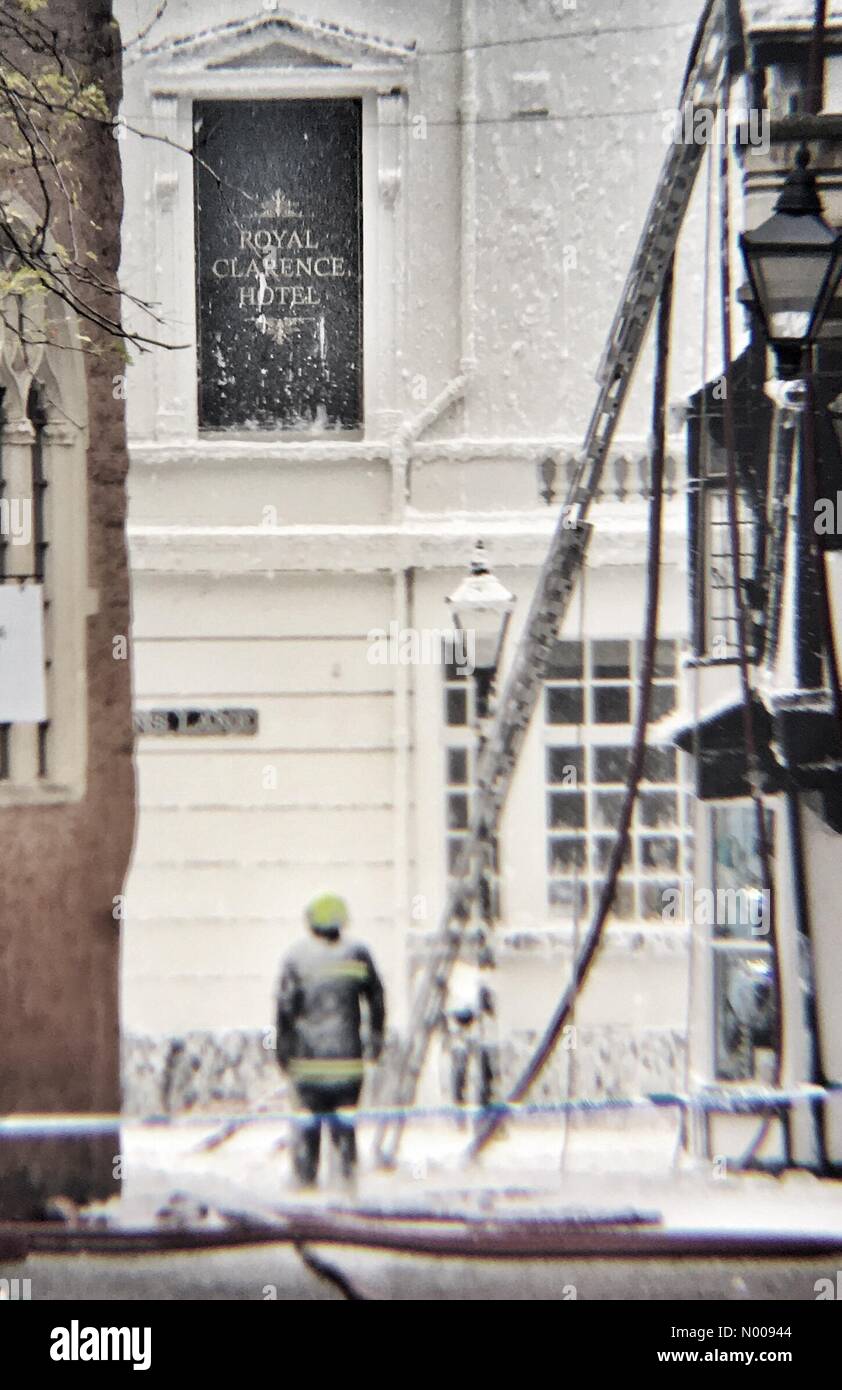 Firefighter stands covered in foam next to Clarence Hotel, Exeter Stock ...