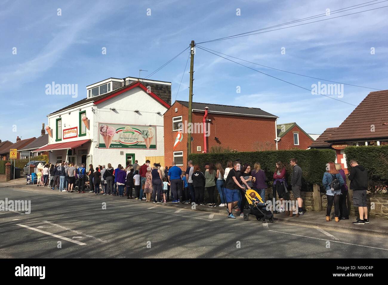 UK Weather: Sunny day in Chorley, Lancashire. People queuing outside ...