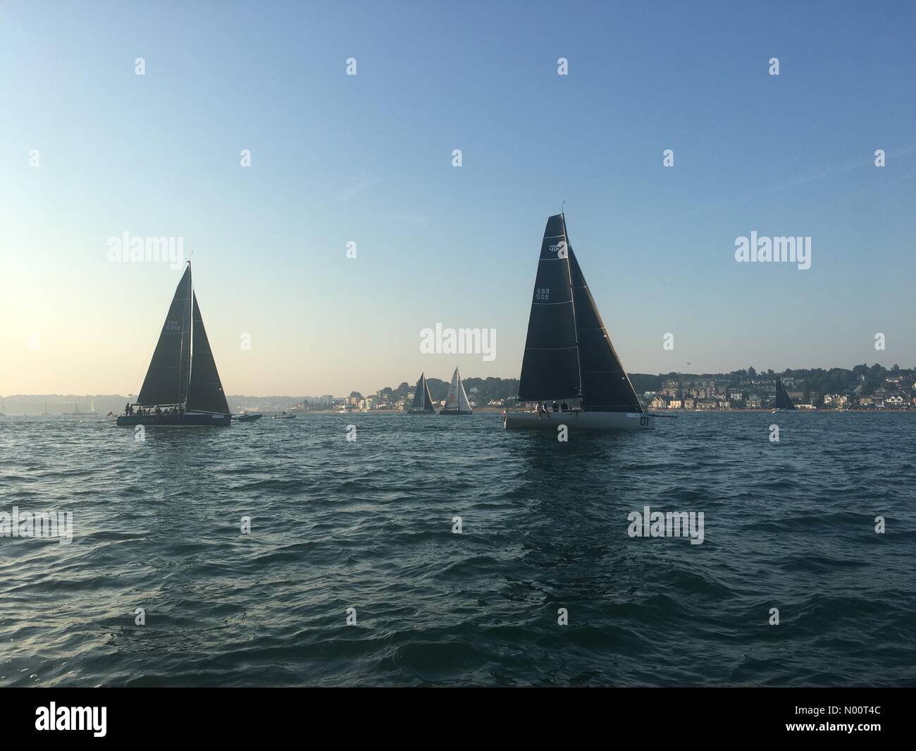 Round the island race first boats over line Stock Photo - Alamy