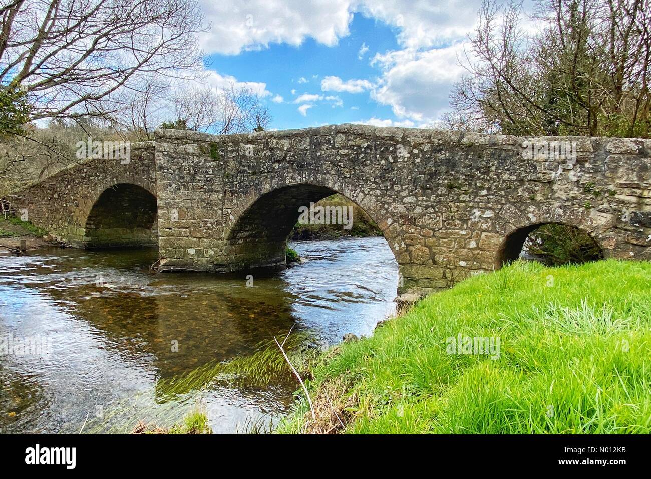 Ashton, Devon, UK. 1st April, 2020. Pretty Ashton Bridge over River ...