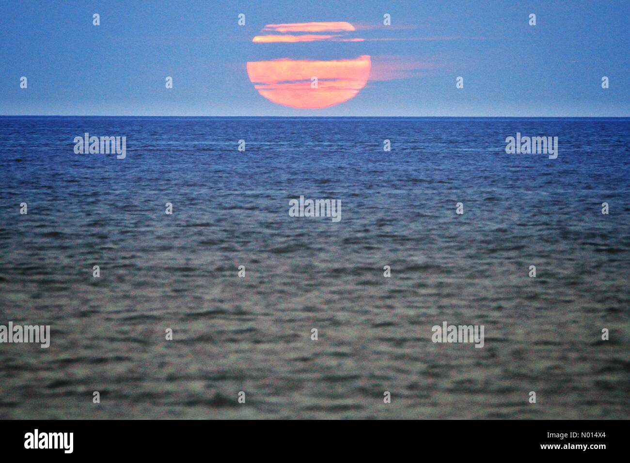 Teignmouth, Devon, UK. 26th May 2021. Full Flower moon rises over the ...