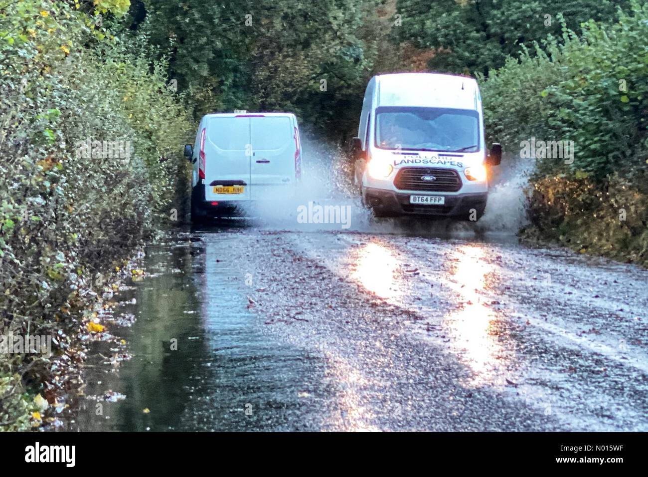 UK Weather: cars and vans drive through flood on Teign valley road ...
