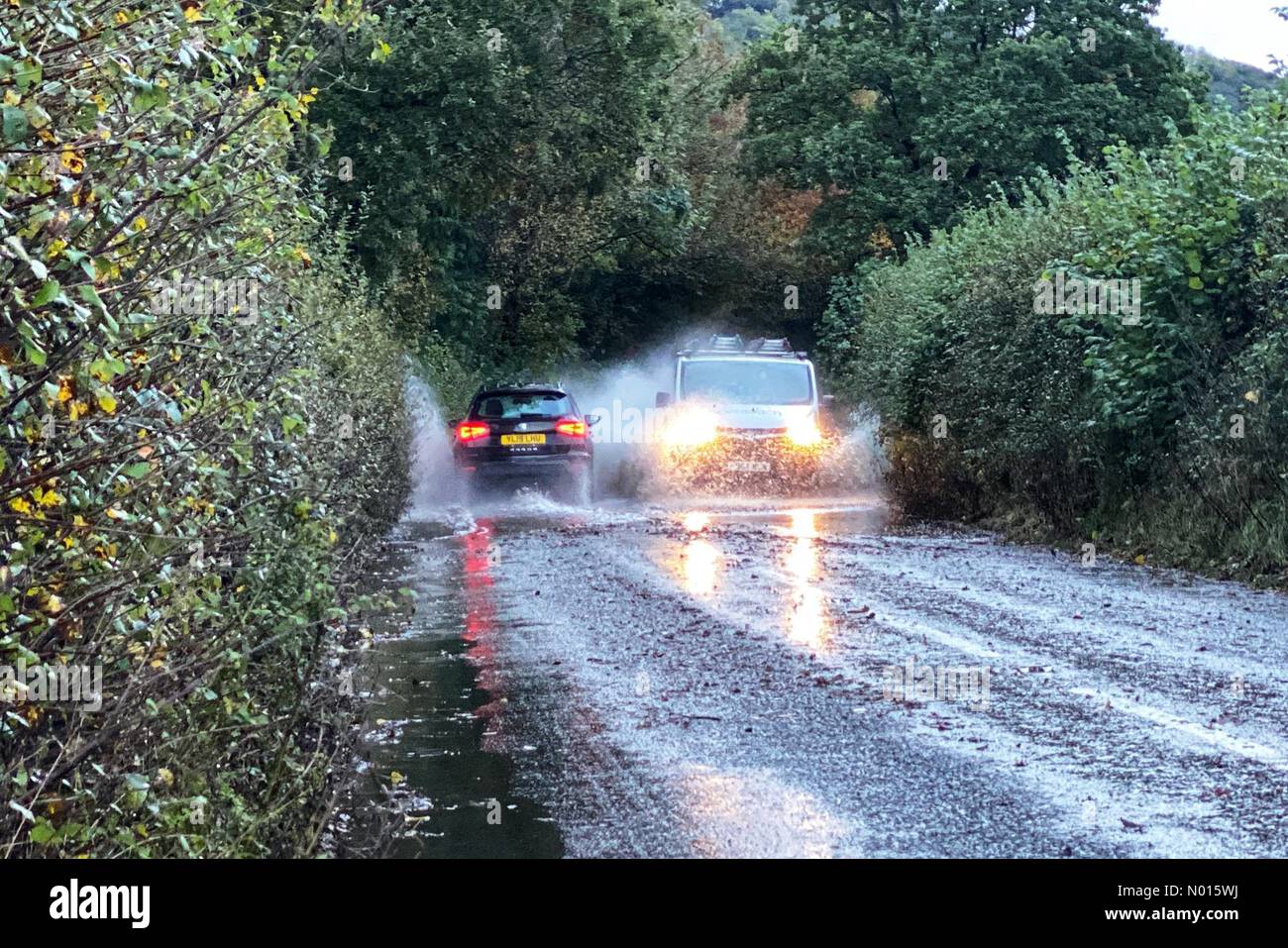 UK Weather: cars and vans drive through flood on Teign valley road ...
