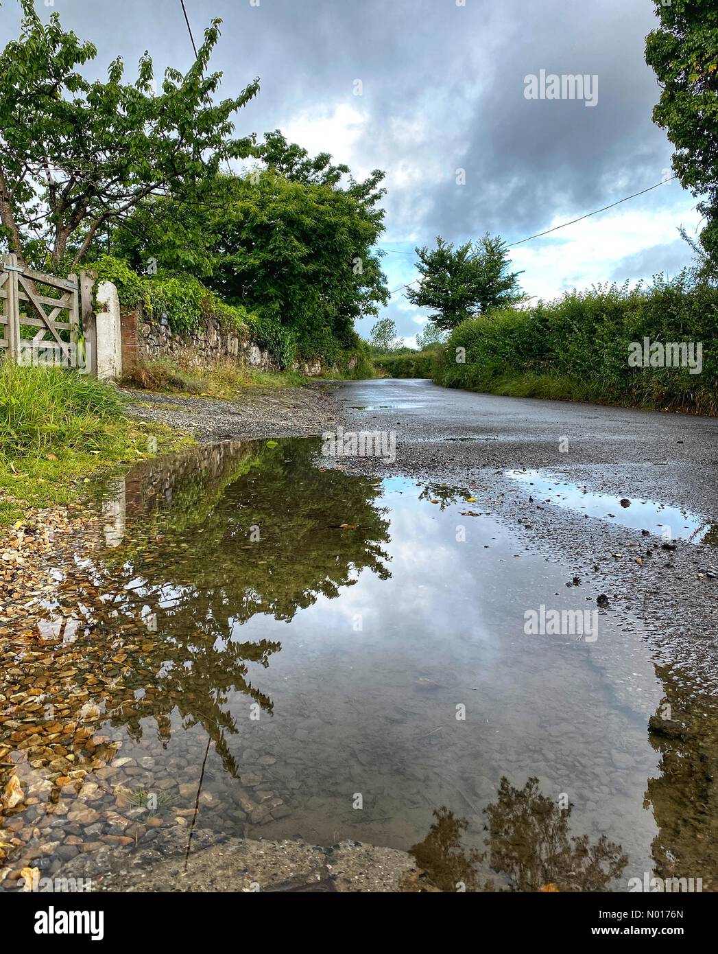 Puddle in country lane hi-res stock photography and images - Alamy