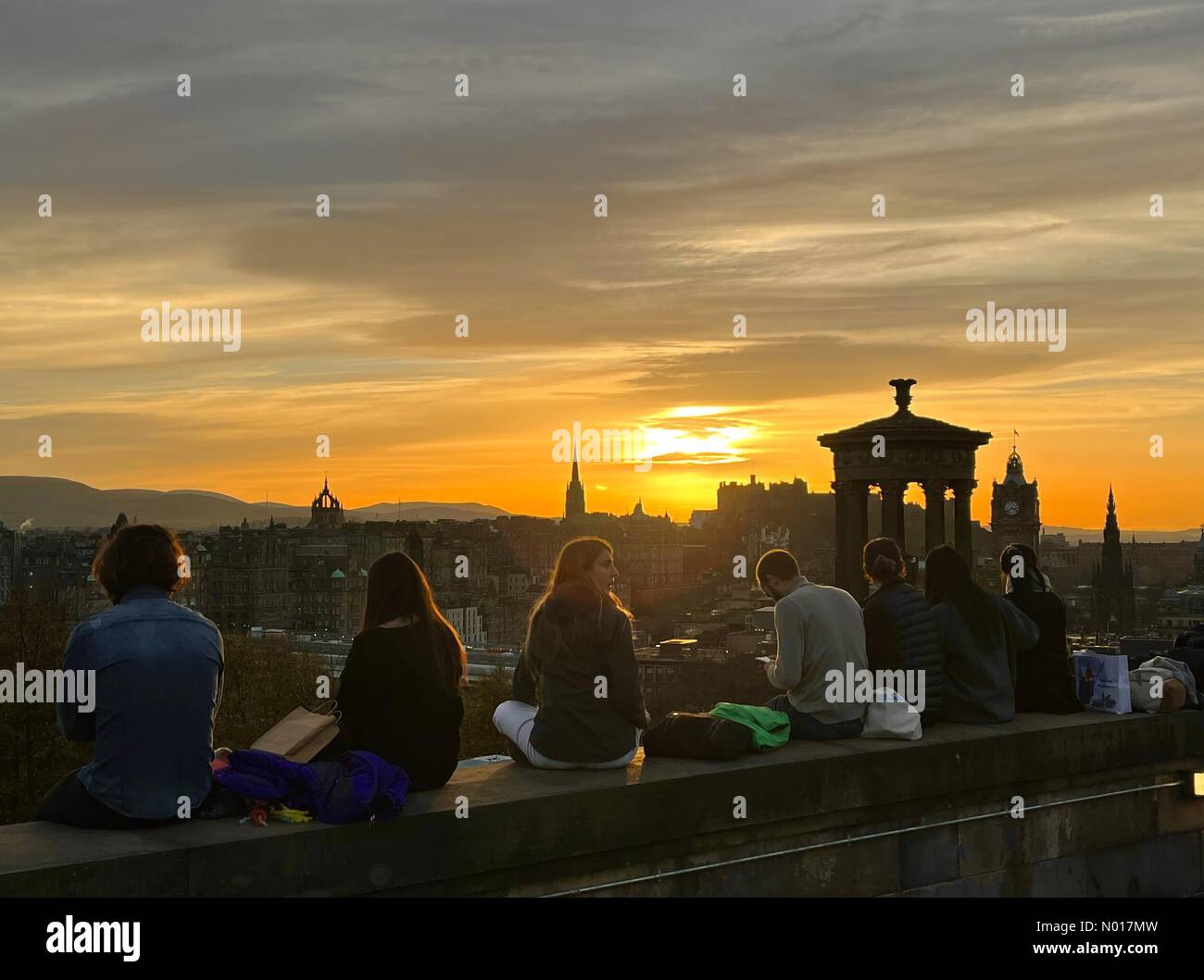 Edinburgh, Scotland, UK. 13 November 2022. Tourists sit on Calton Hill ...