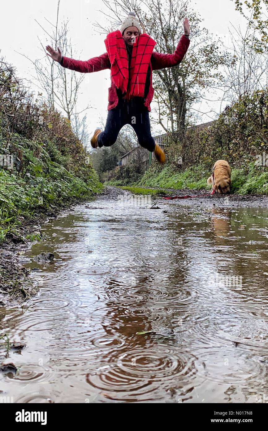UK Weather: Raich Keene and Raphael the retriever puddle stompin' on a rainy walk. Lower Ashton ...