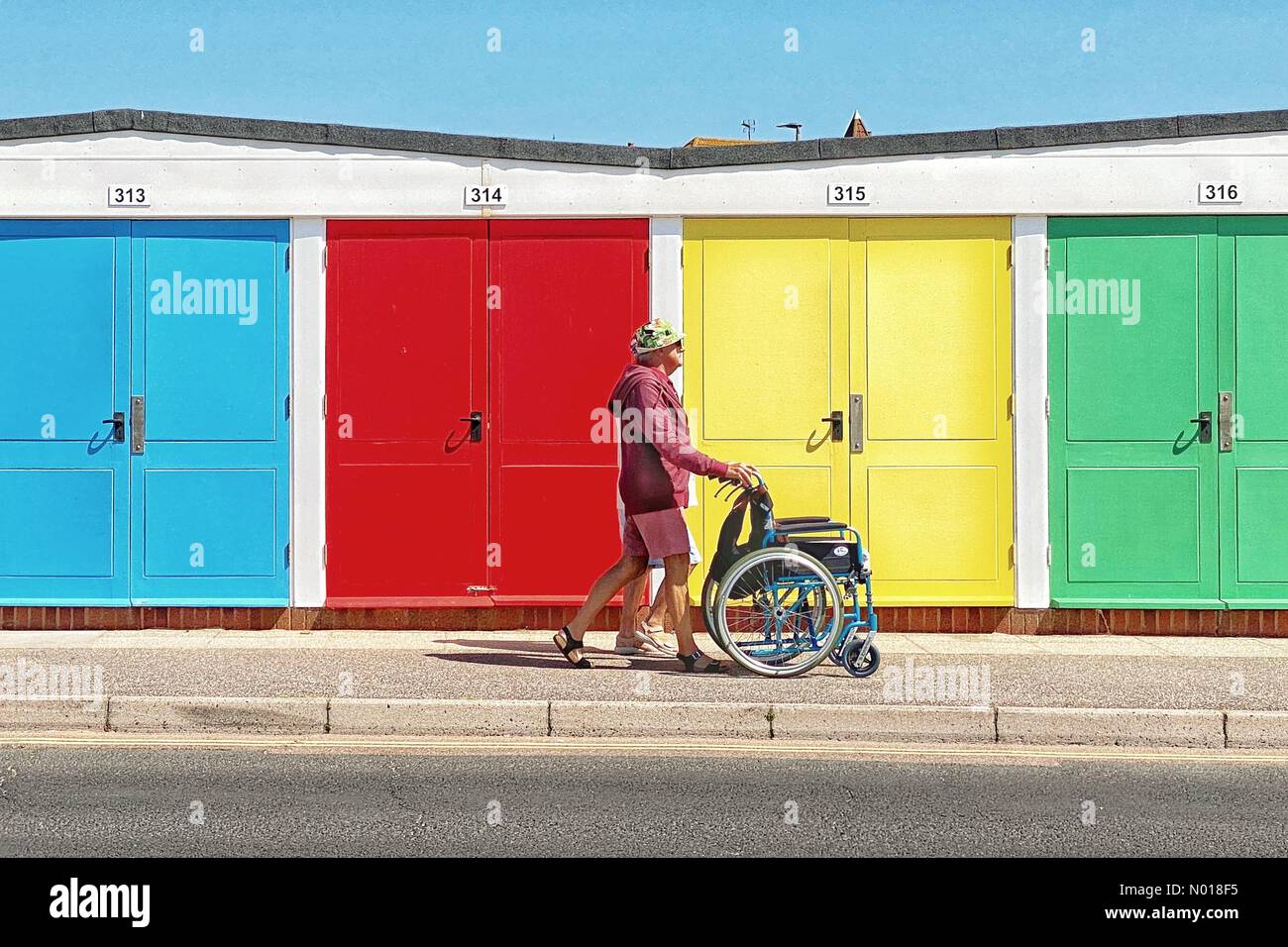 Exmouth Beach, Devon, UK. 26 May, 2023. Colourful beach huts at a sunny ...