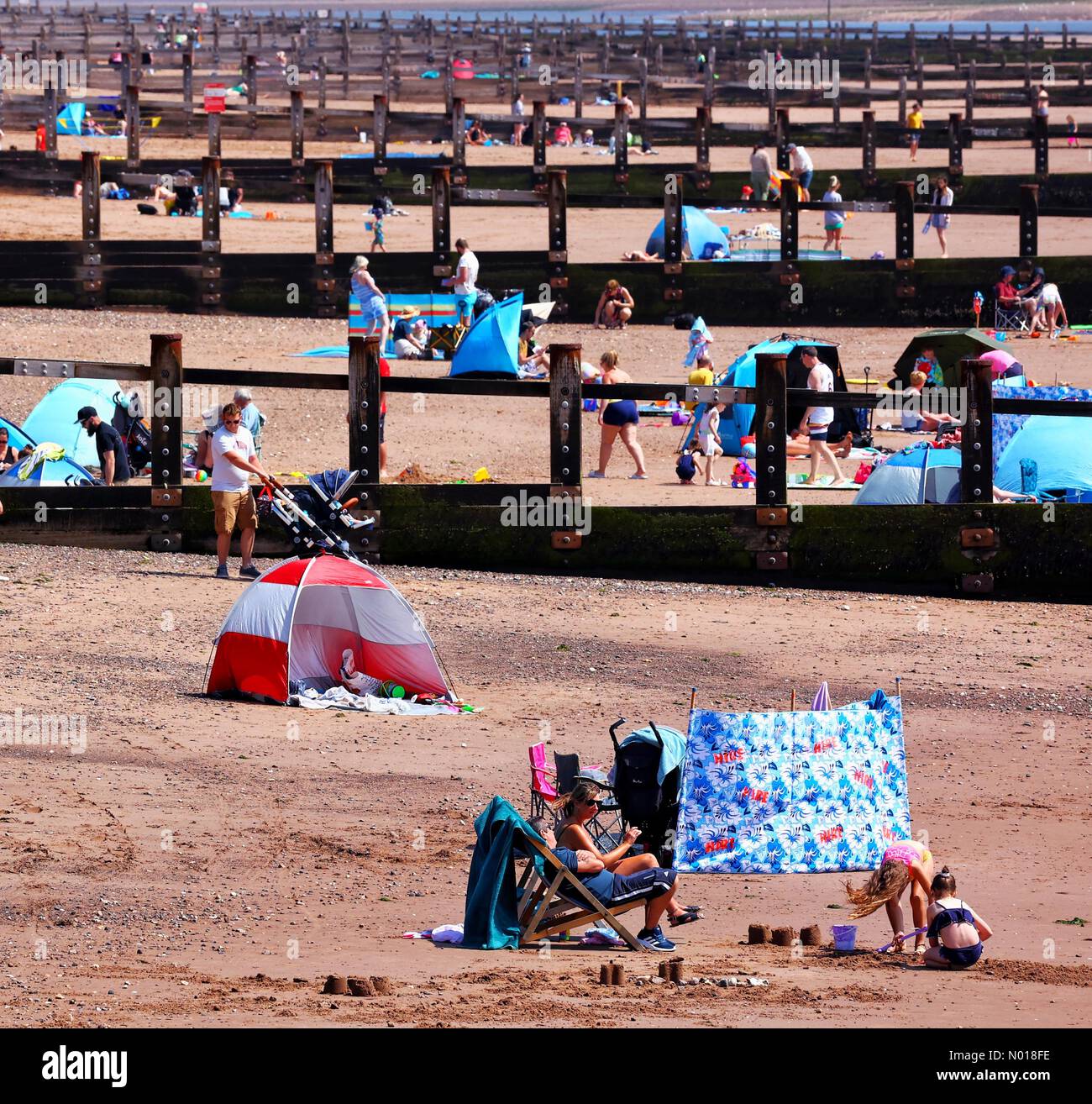 UK Weather: People enjoy sun, sea and sand at Dawlish Warren beach ...
