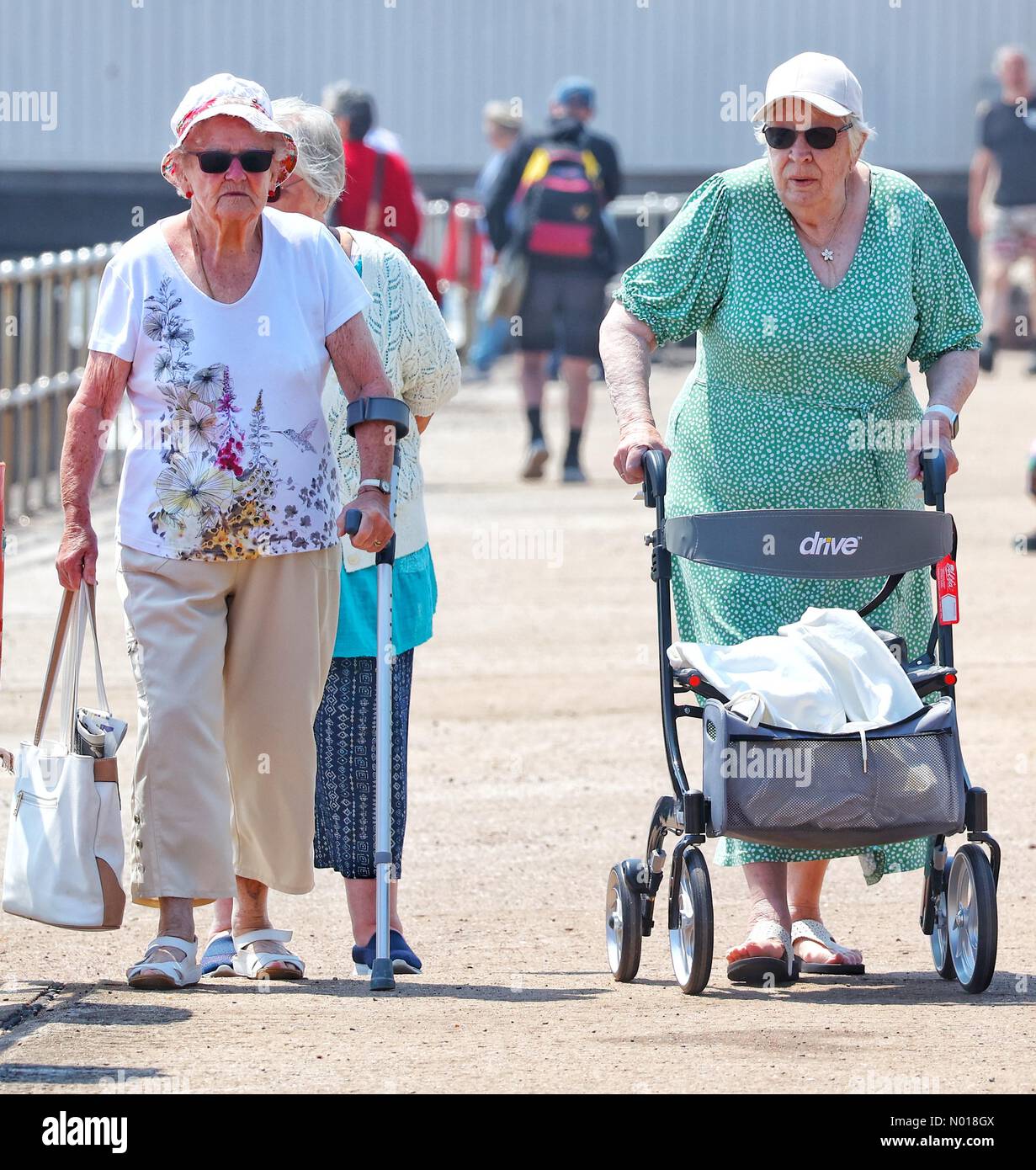 UK Weather: Ladies enjoy a stroll in sunshine at Teignmouth, Devon, UK ...