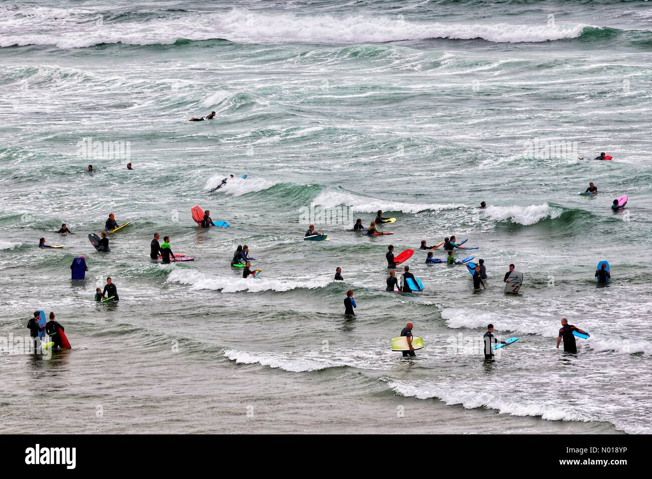 Surfers and bodyboarders at Polzeath, Cornwall, UK. 27 August, 2023 ...