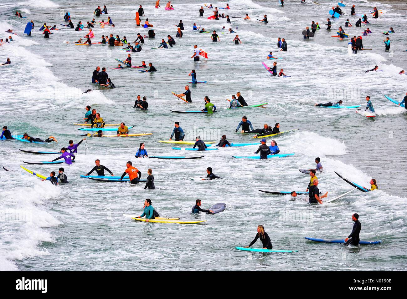 UK Weather: surfers crowd in waves during sunny spells at busy seaside ...