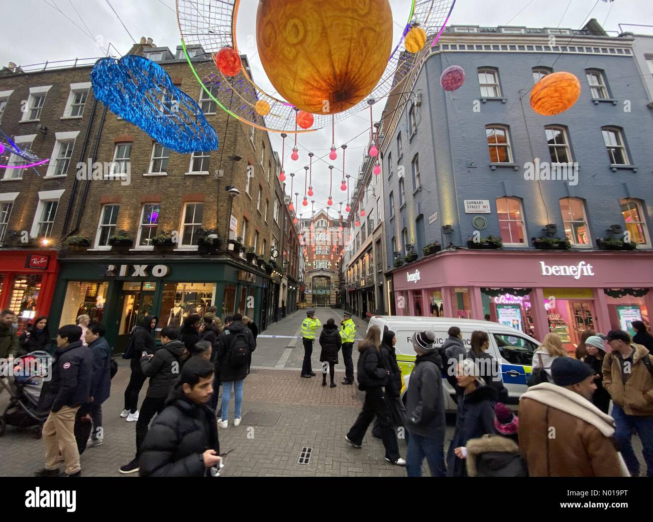Police officers and a forensics van at the scene of stabbing off a busy ...