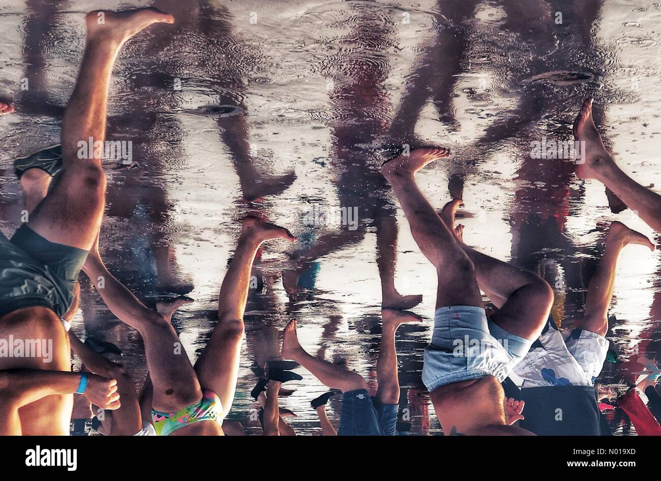 Reflections of colourful swimmers at Boxing Day dip. Teignmouth, Devon ...