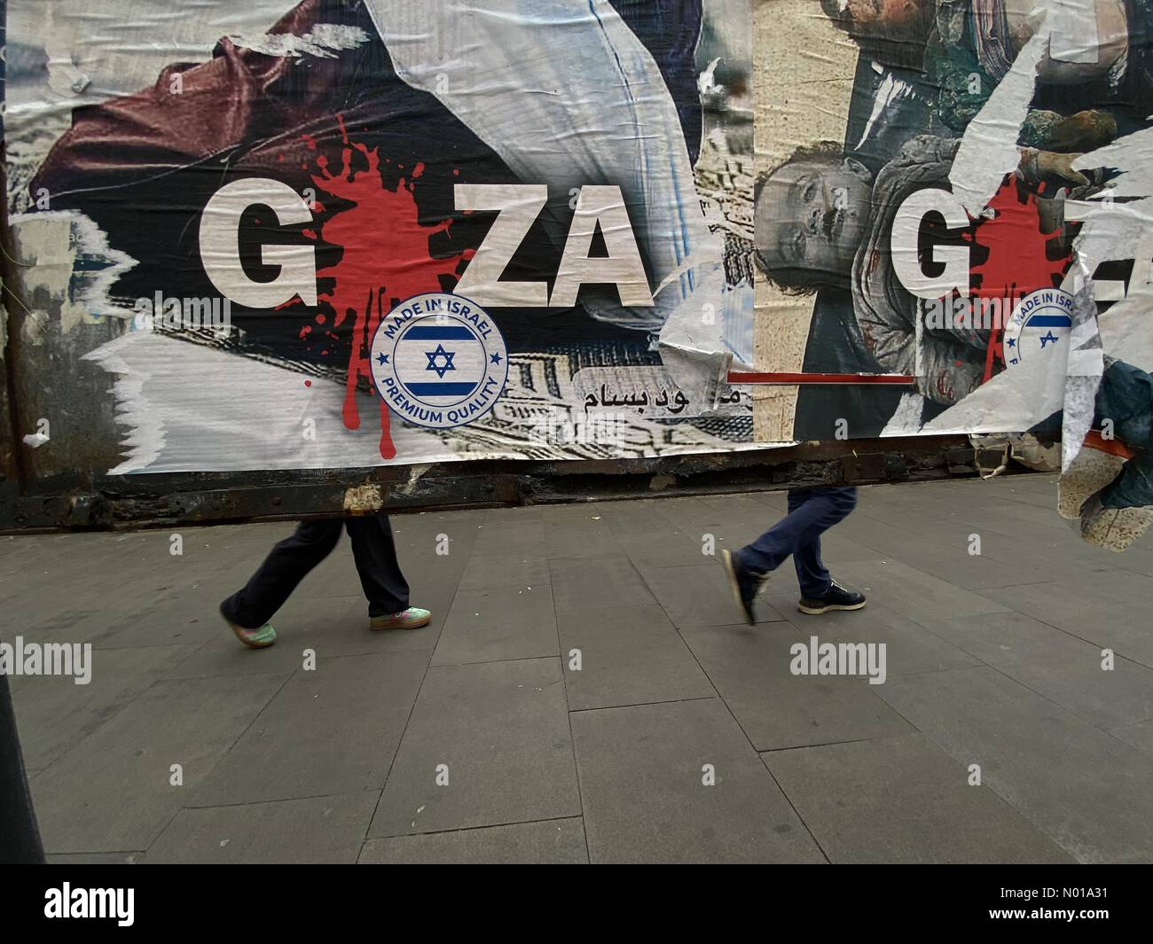 Rome Italy. 3 January 2024. People walk past a blood spattered poster ...