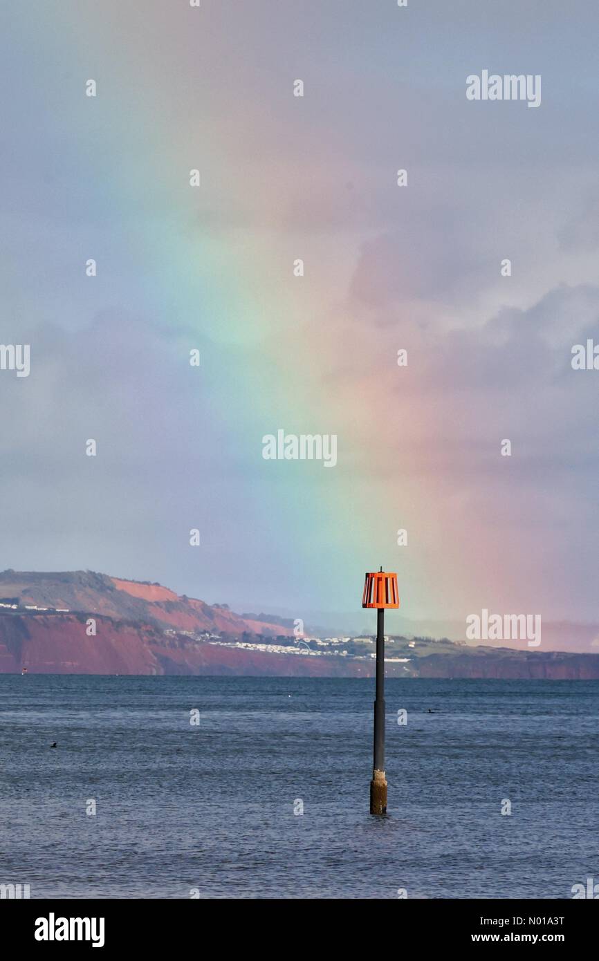 UK Weather: Rainbow at Teignmouth beach, Devon, UK. 5 Jan, 2024. Credit ...
