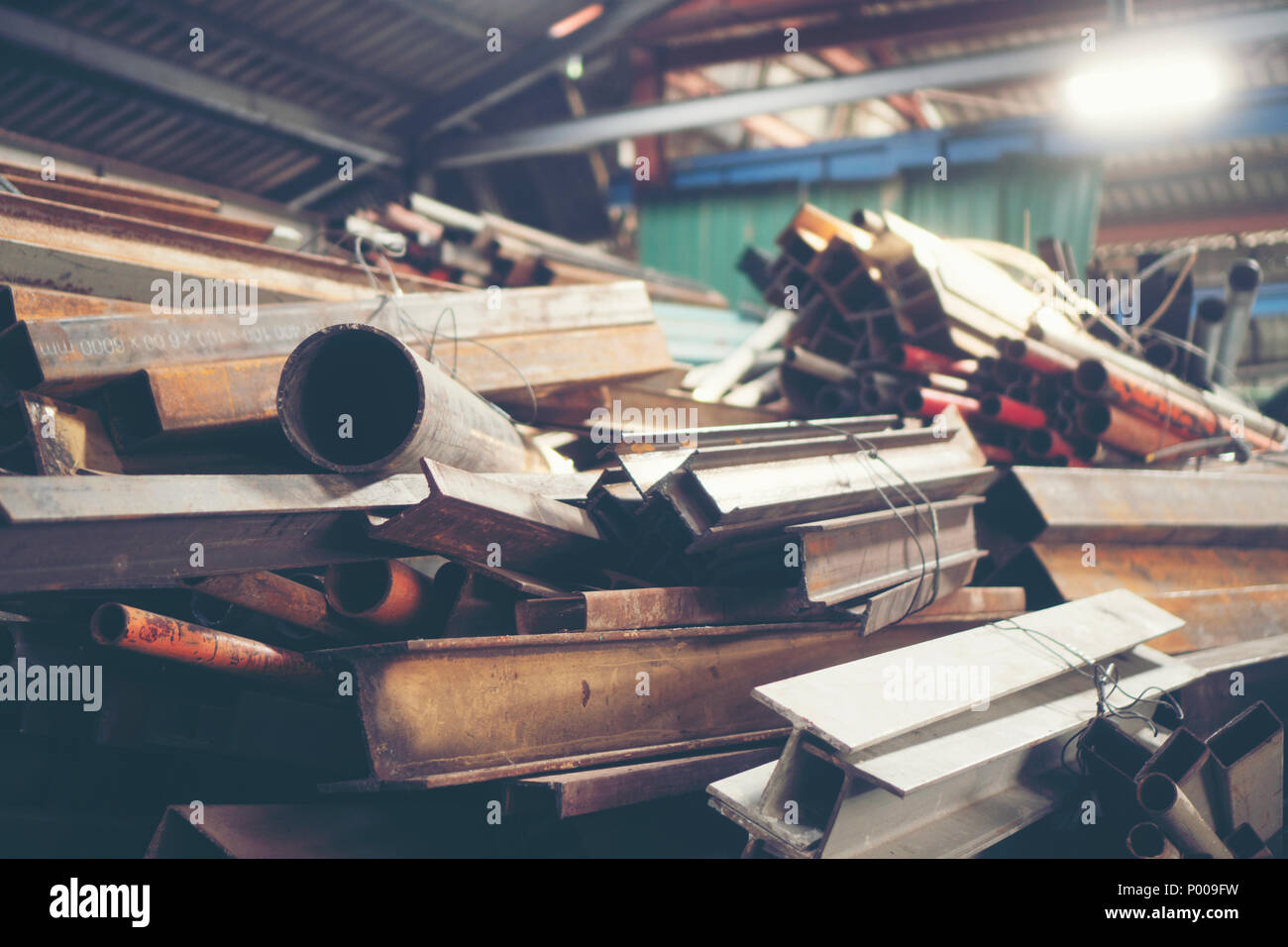 Stack of steel pipes in metal factory shop Stock Photo - Alamy
