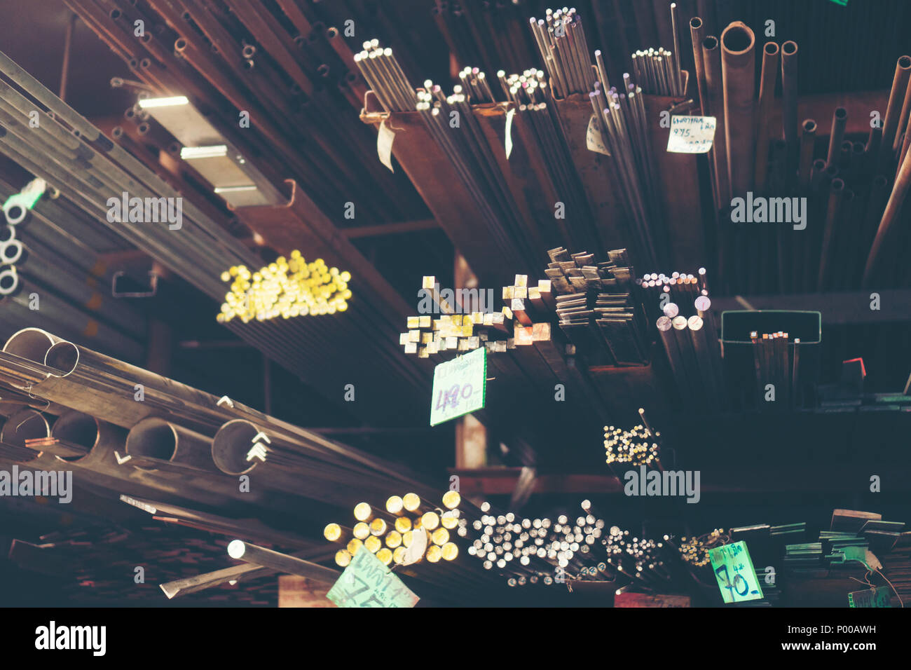 Stack of steel pipes in metal factory shop Stock Photo - Alamy