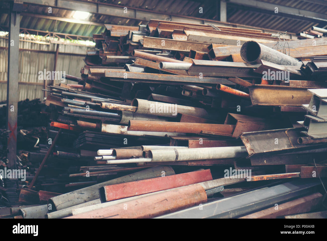 Stack of steel pipes in metal factory shop Stock Photo - Alamy