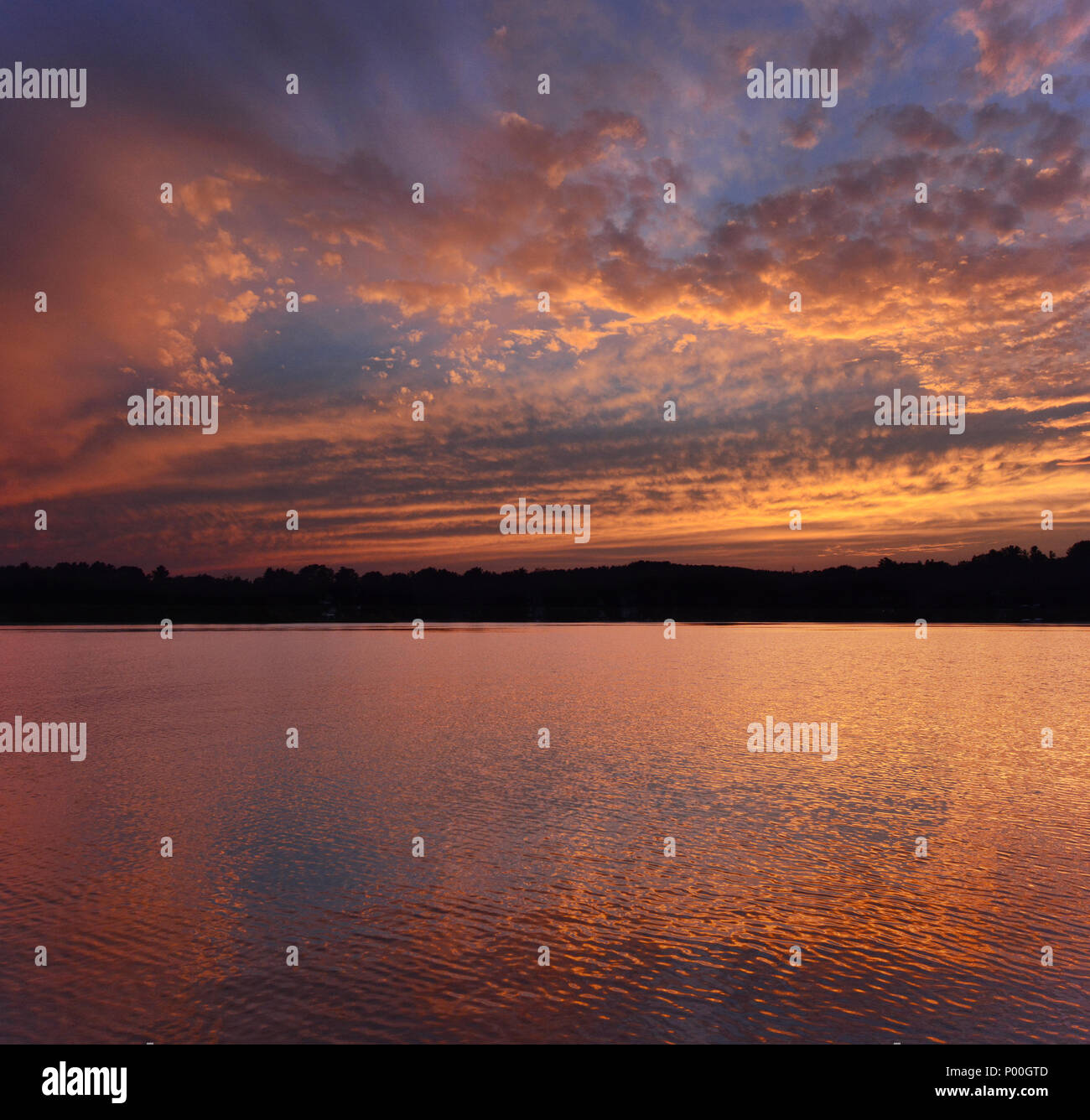 Beautiful sunset reflected in a shimmering body of water Stock Photo ...