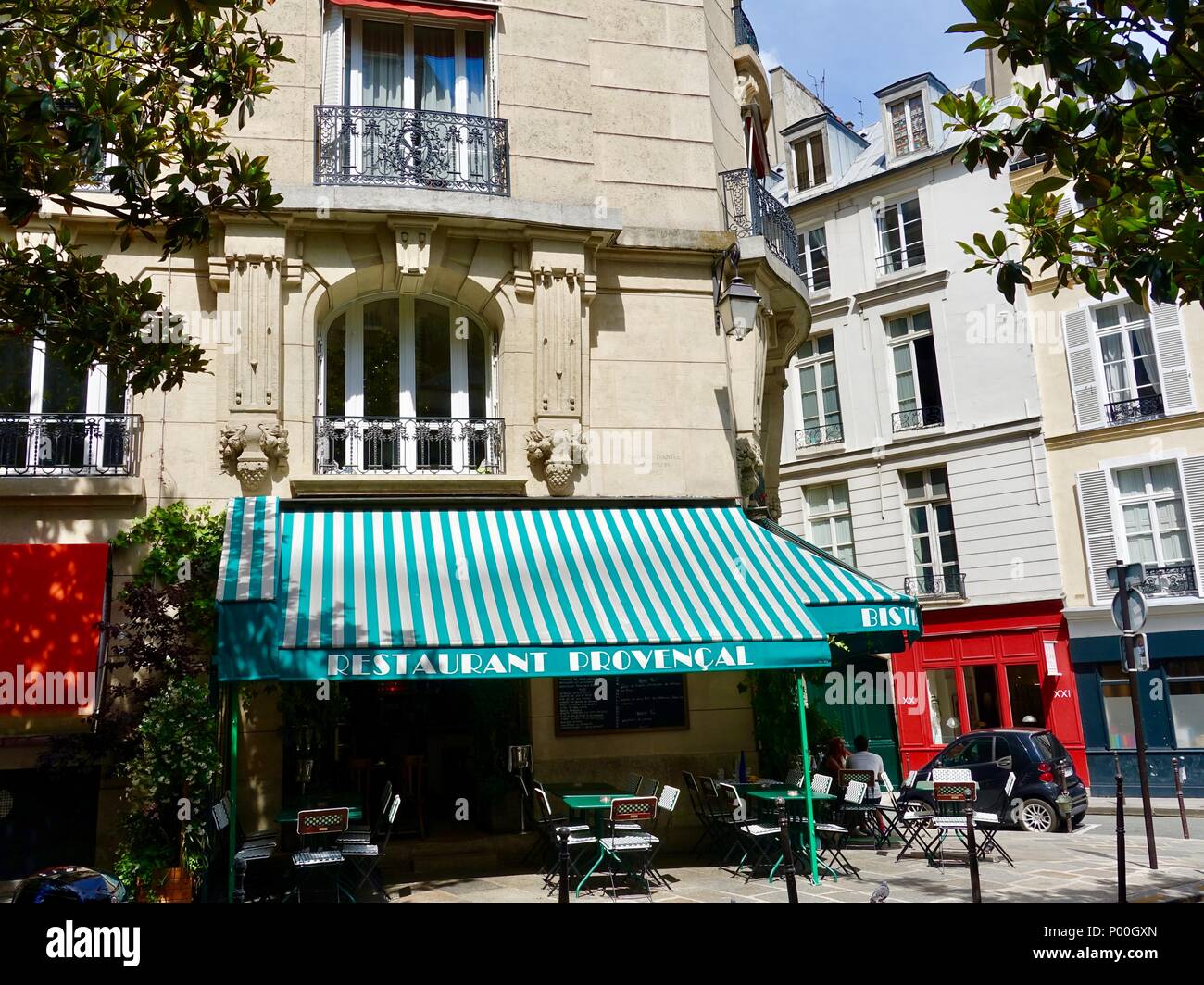 Almost empty outdoor terrace at Chez Janou restaurant in a shady corner ...