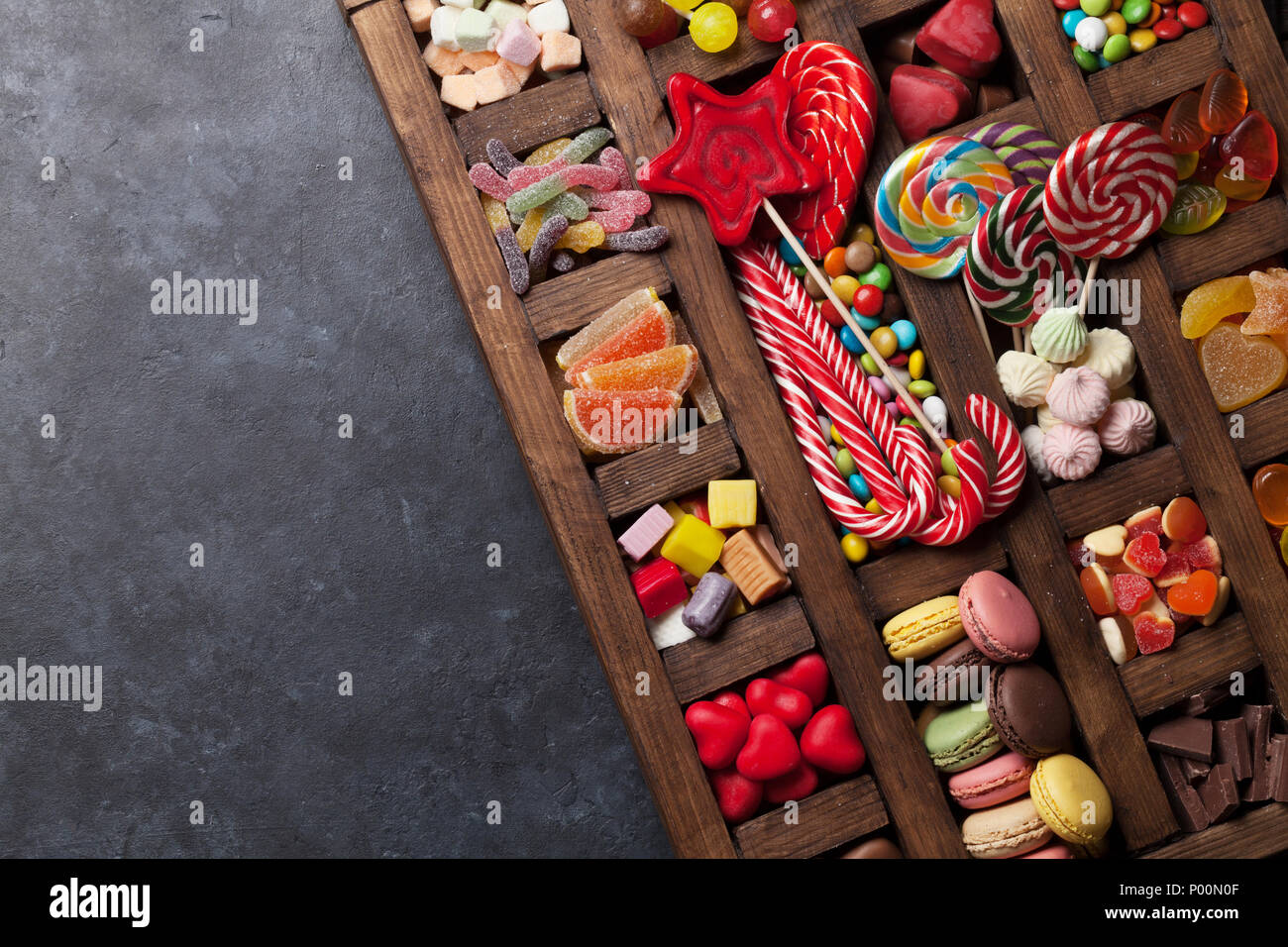 Colorful sweets box. Lollipops, macaroons, marshmallow, marmalade and ...