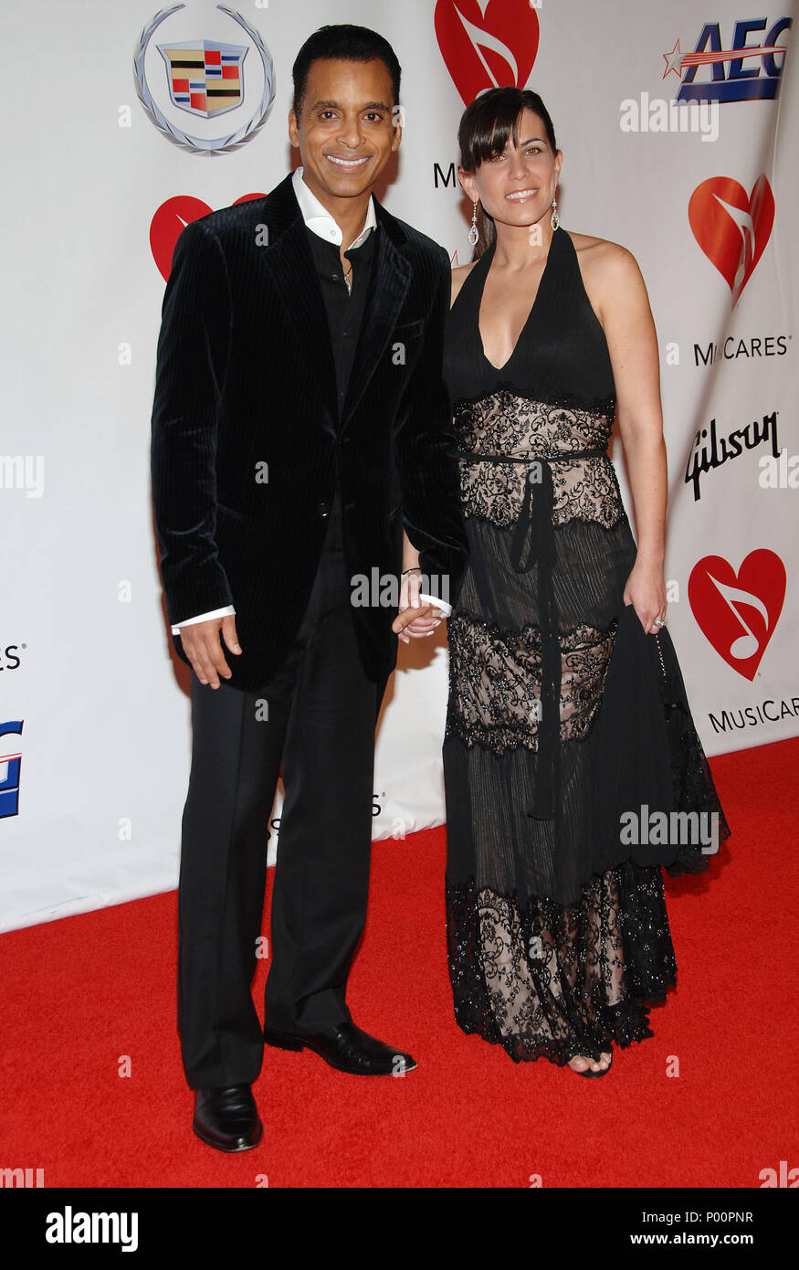 Jon Secada and wife arriving at the MusiCares Person Of The Year James ...