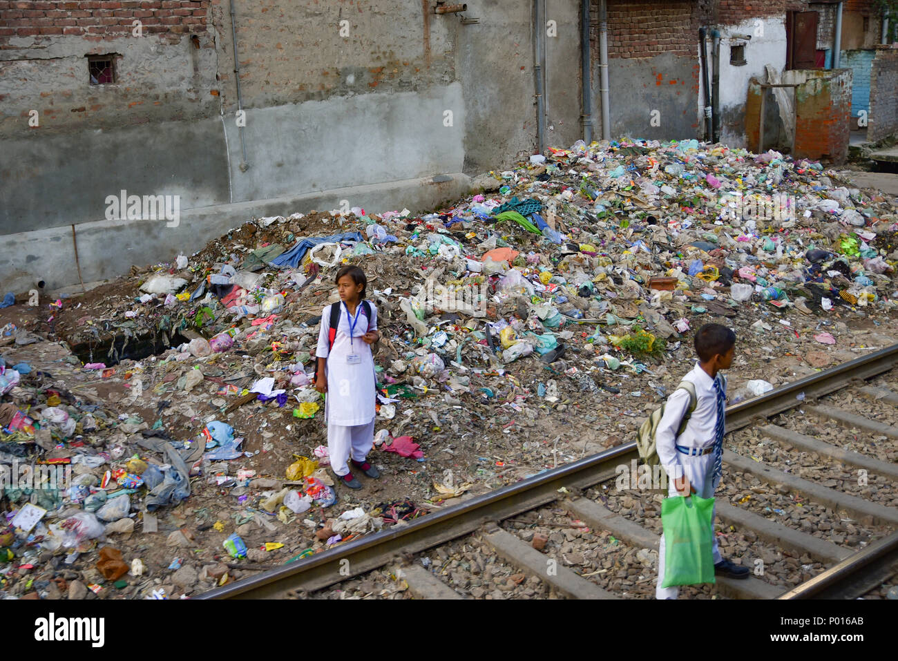 Indian people on the railway with garbage around in New Delhi, capital ...