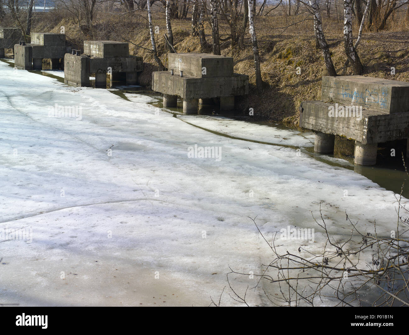 Concrete constructions on a river, covered with ice, outdoor shot Stock ...
