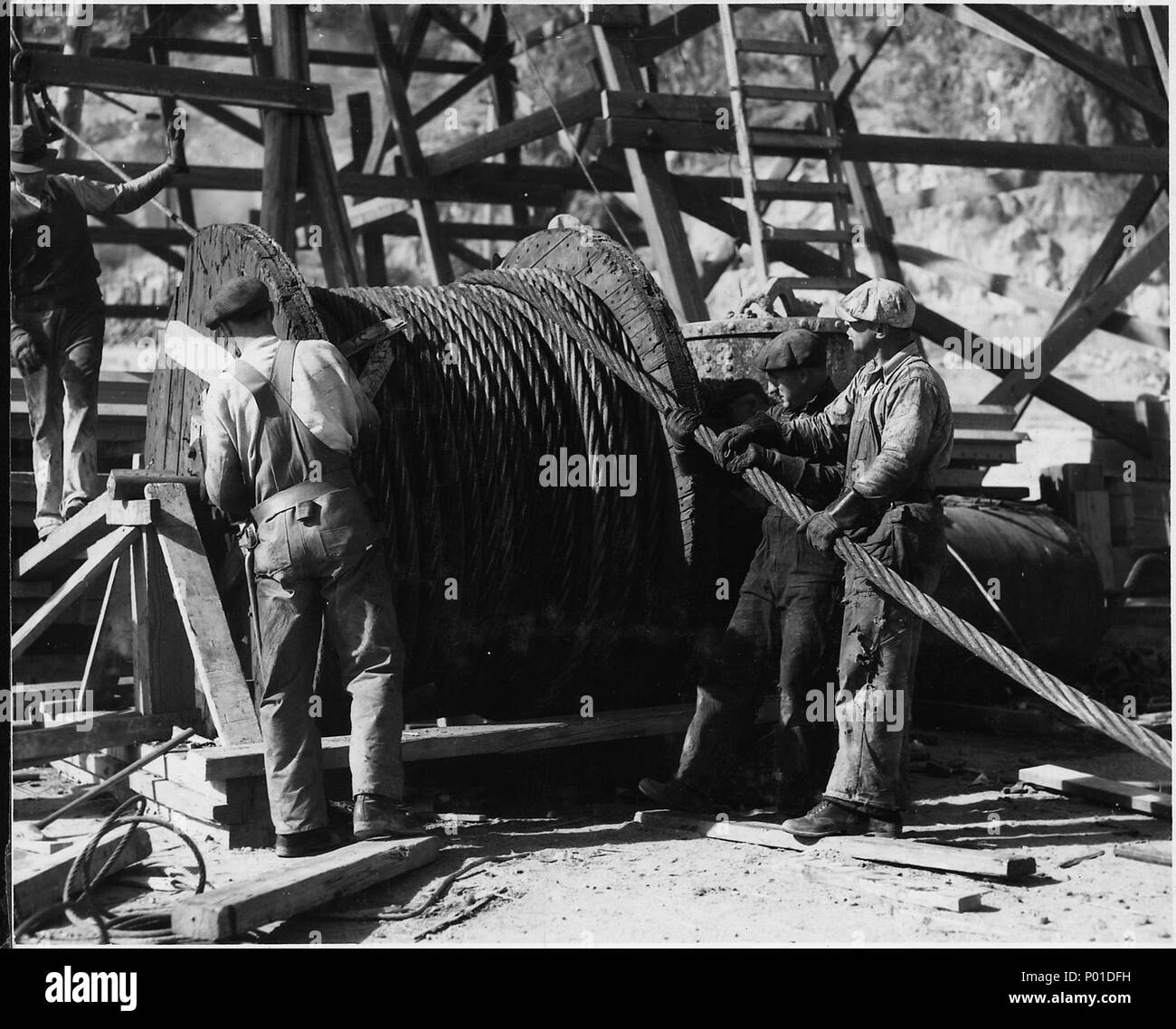 Reeling up highline cable used in erecting highway bridge ...