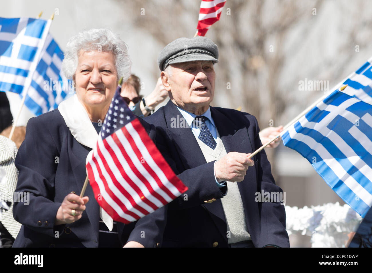 Chicago, Illinois, USA - April 29, 2018 Older Greek couple wave the USA ...