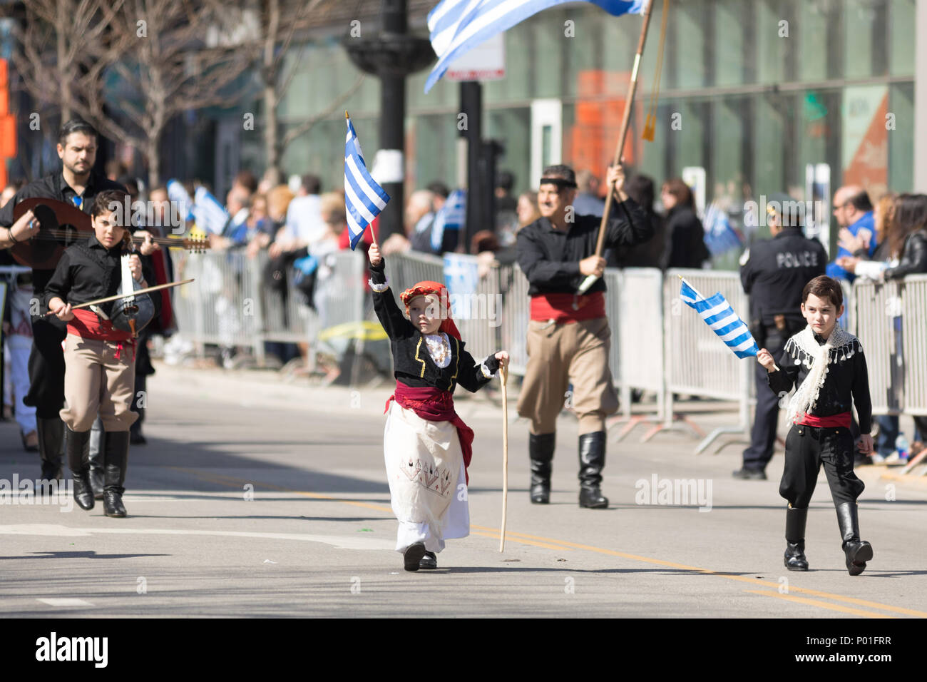 Chicago, Illinois, USA - April 29, 2018 Greek children and men carring ...