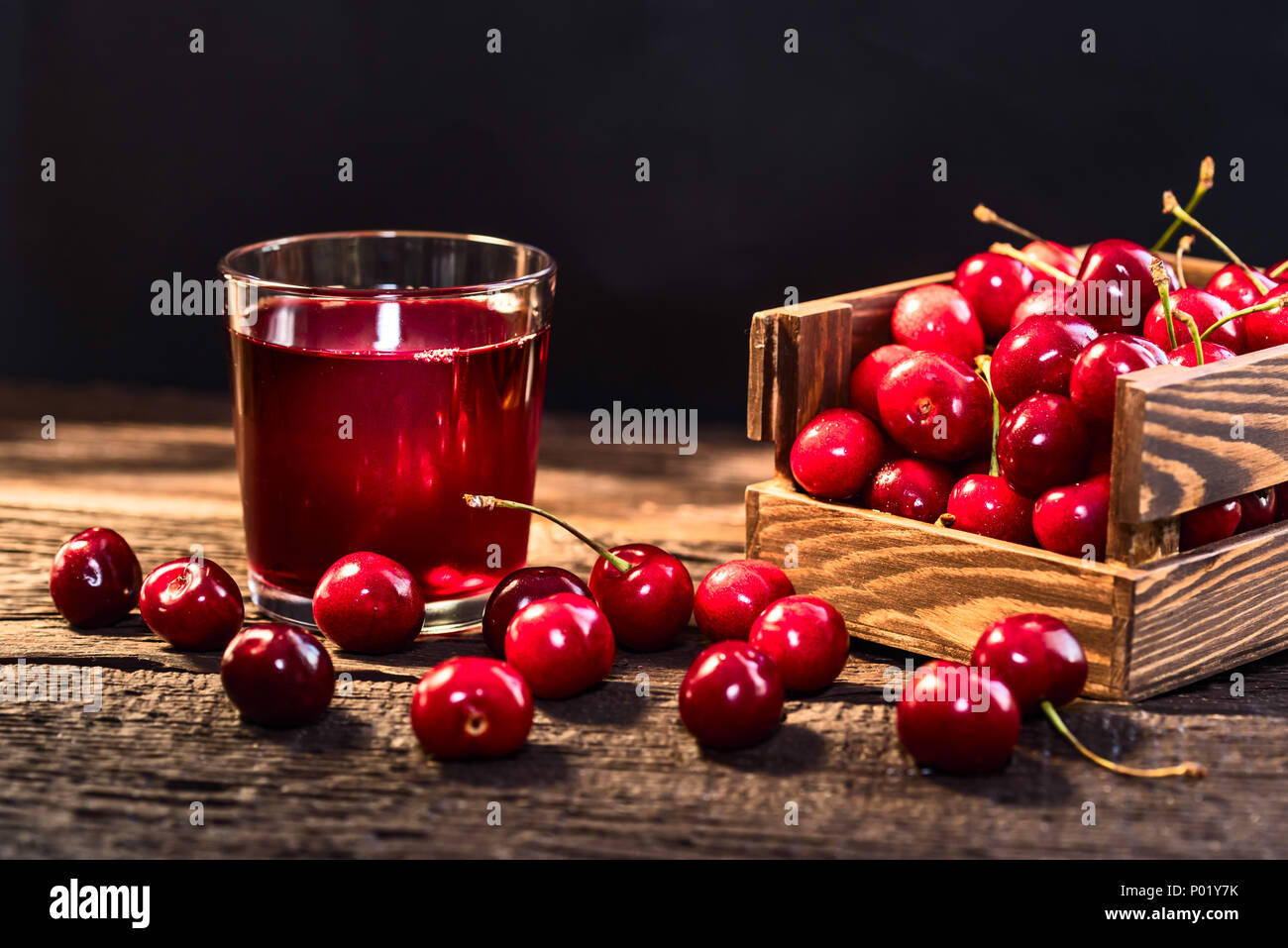 Fresh cherries in a wooden box and cherry juice Stock Photo - Alamy