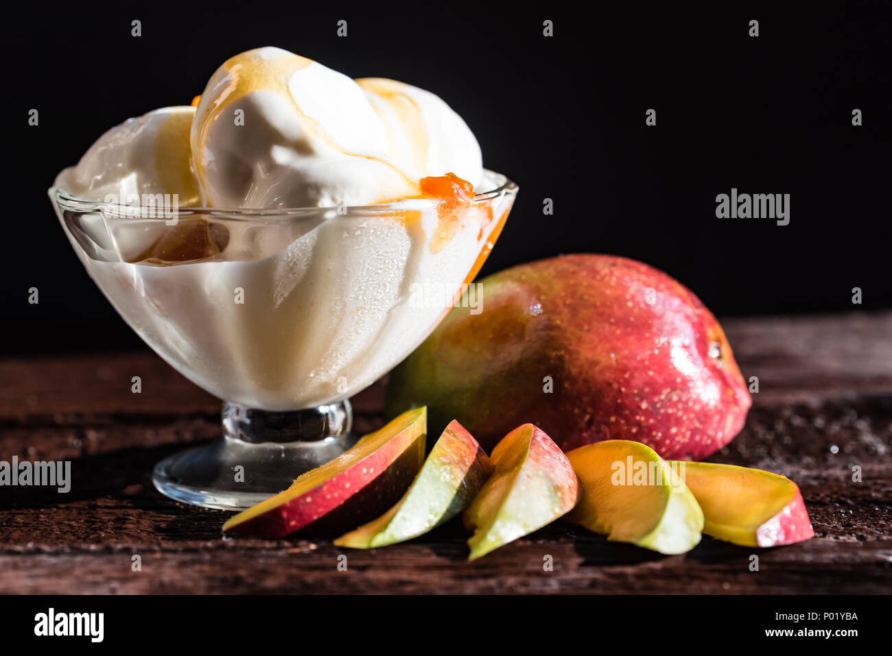 Caramel sauce ice cream and fresh mango fruit Stock Photo - Alamy