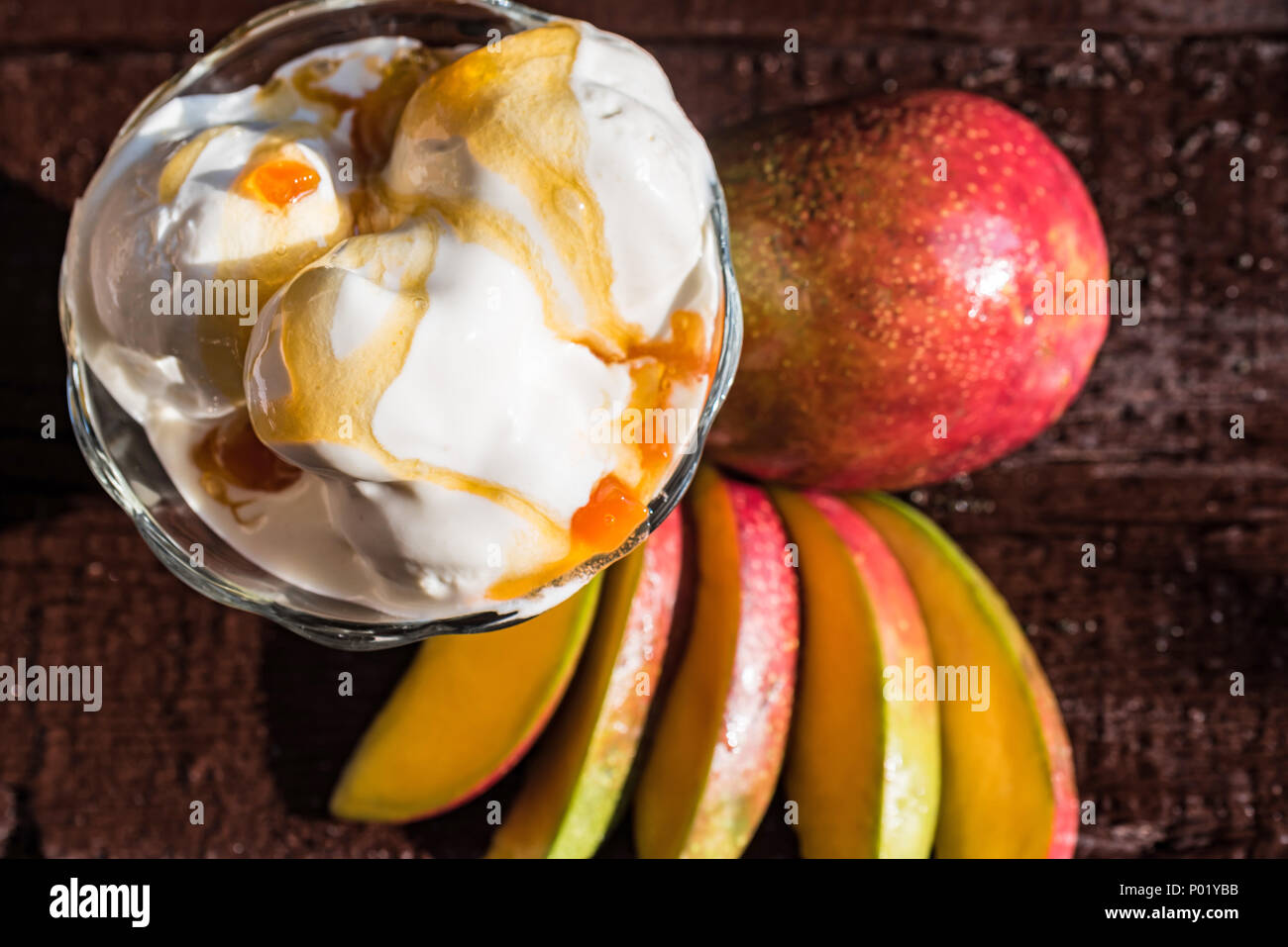 Caramel sauce ice cream and fresh mango fruit Stock Photo - Alamy