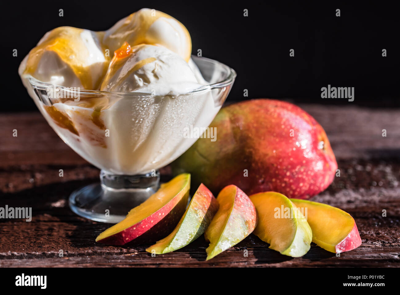 Caramel sauce ice cream and fresh mango fruit Stock Photo - Alamy