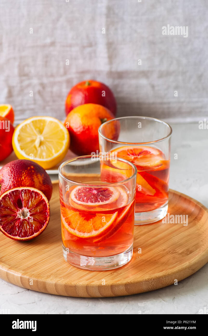 Citrus infused water with slices of fruits. Seasonal beverages concept ...