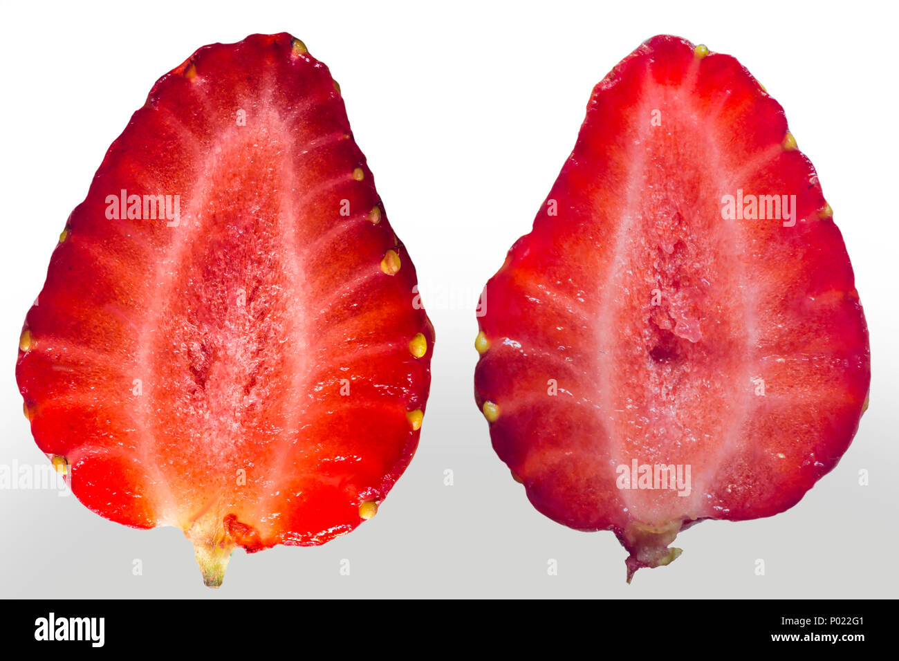 Macro photograph of two halves of a ripe strawberry. Isolated image on ...