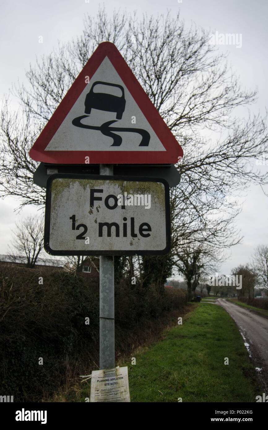 Road sign slippery road Stock Photo - Alamy