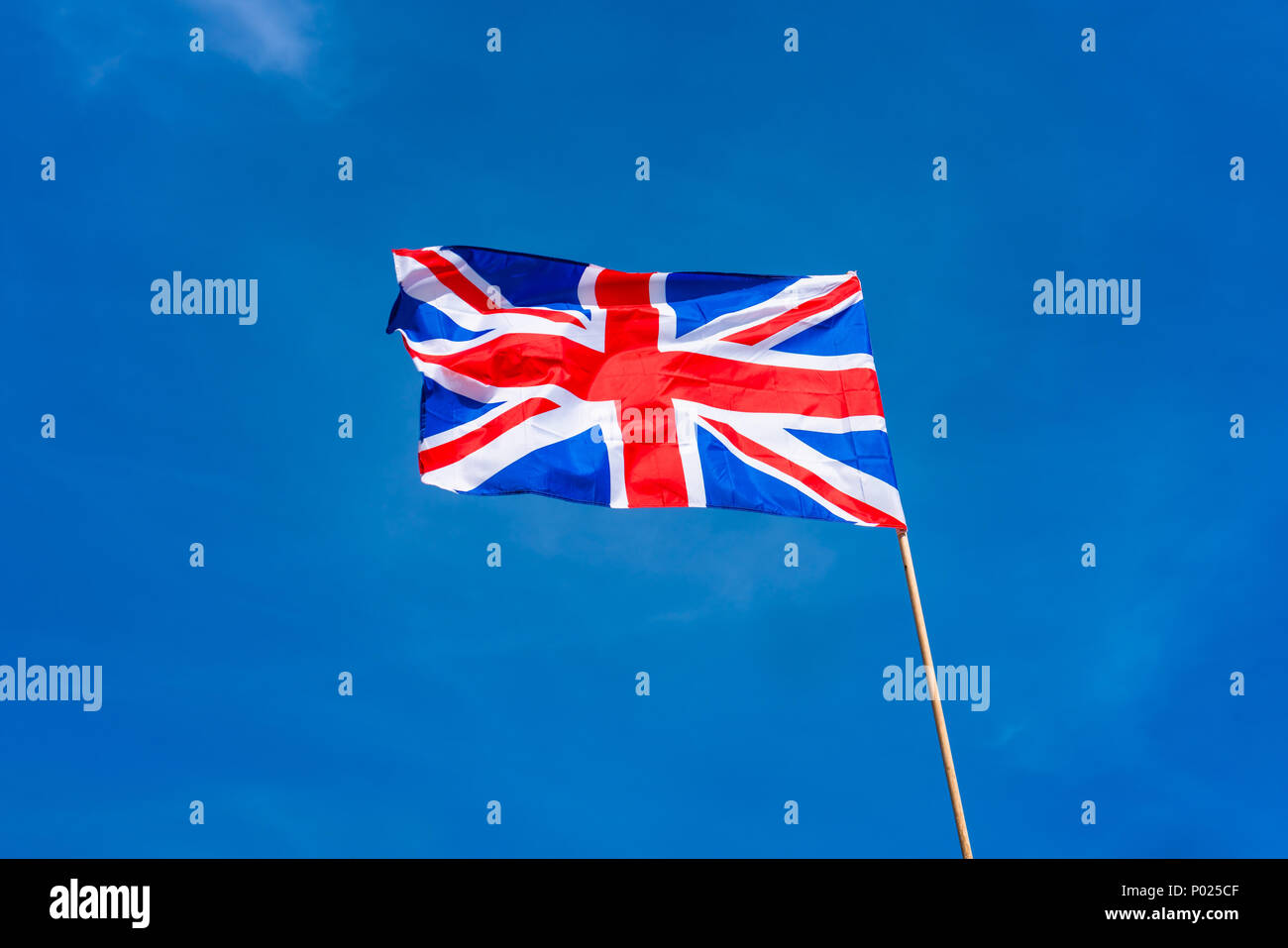 A British flag flying against blue sky Stock Photo - Alamy