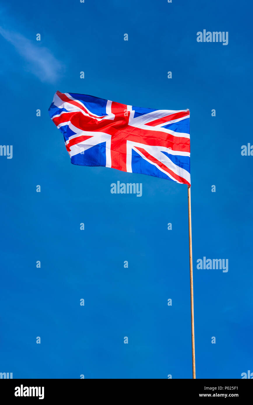 A British flag flying against blue sky Stock Photo - Alamy